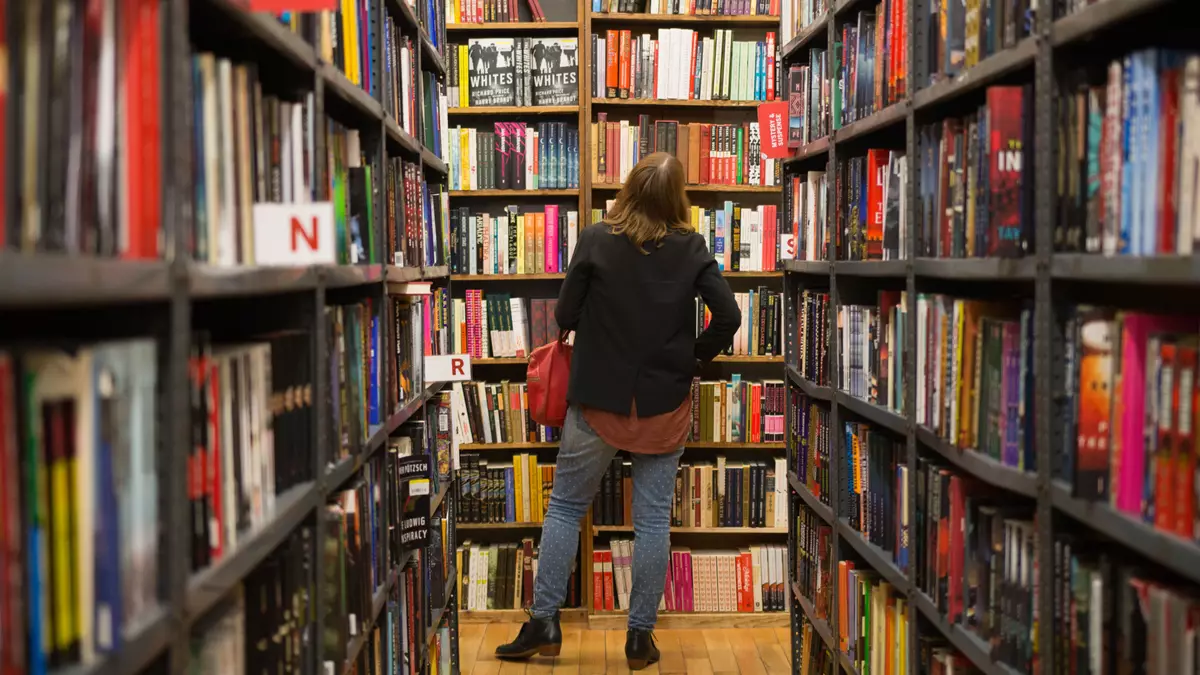 Osoba przegląda książki w nowojorskiej księgarni