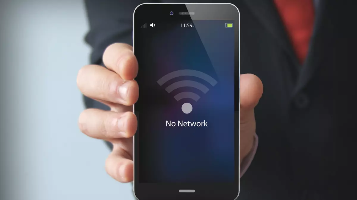 Concepte de comunicacions empresarials i de mobilitat: home de negocis amb un telèfon intel·ligent modern sense icona de xarxa