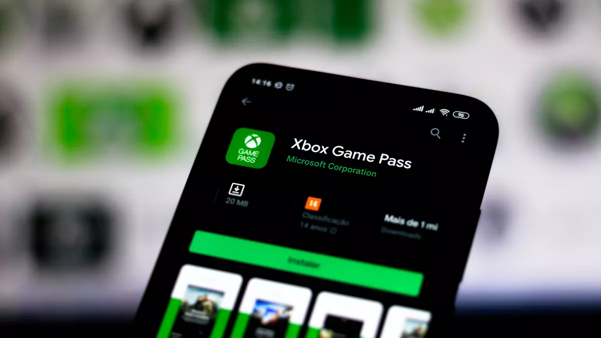 ในภาพประกอบรูปภาพนี้ แอปโลโก้ Xbox Game Pass จะแสดงบนสมาร์ทโฟน
