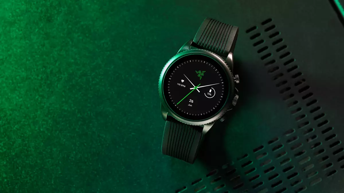 Razer X Fossil Gen 6 smartwatch sa techy surface na may mga berdeng ilaw na nagniningning mula sa gilid