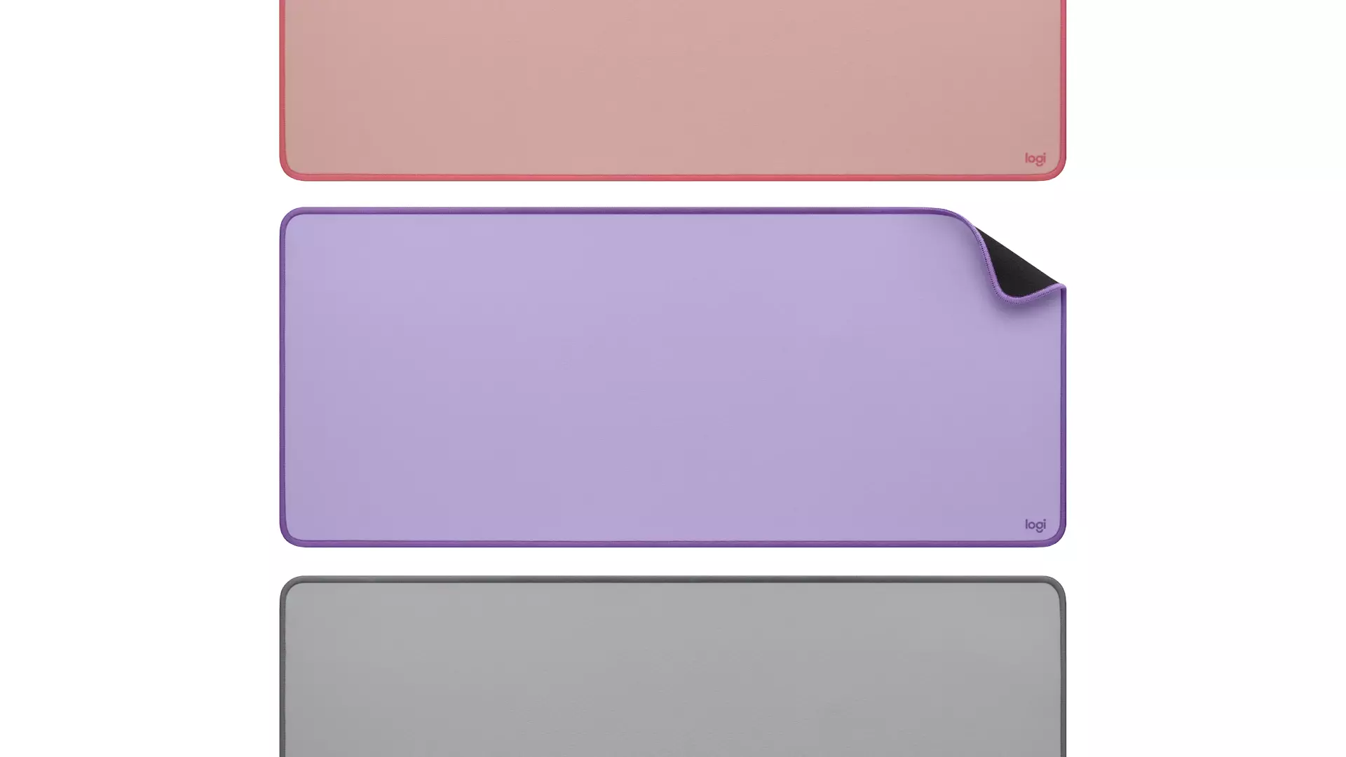 Logitech Desk Mat Studio dalam warna ungu, merah muda kemerahan, dan abu-abu.