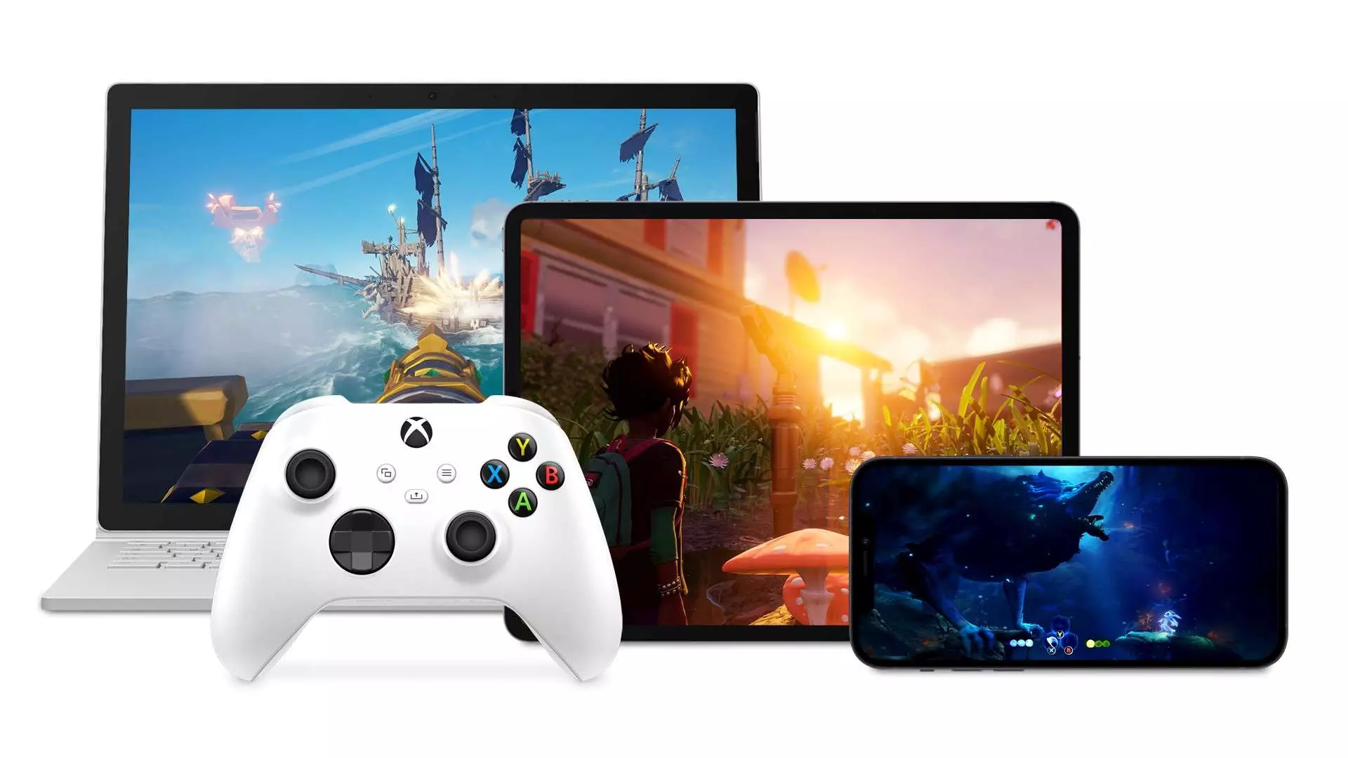Ovladač Xbox před notebookem, iPadem a telefonem s Androidem, všechny hrají hry Xbox