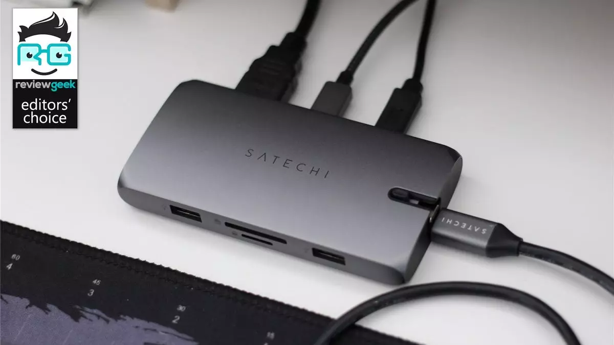 Ang Satechi's On-the-Go Multiport Adapter sa usa ka lamesa nga adunay HDMI ug 2 USB-C nga mga plug nga konektado