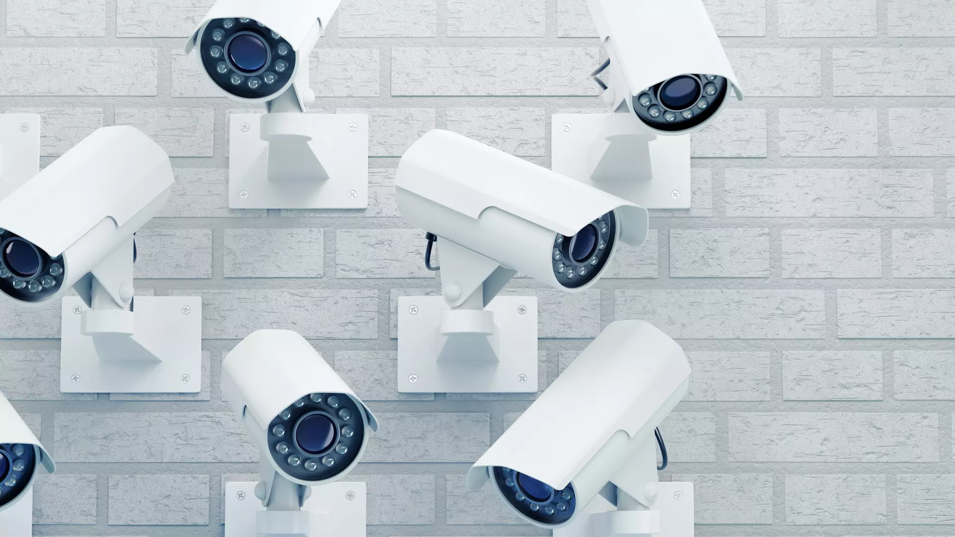 一組安裝在磚牆上的外部監控攝像頭。