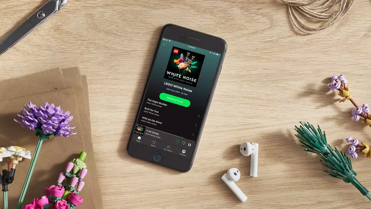 Yon iPhone ak Spotify ouvè a yon album LEGO White Noise.