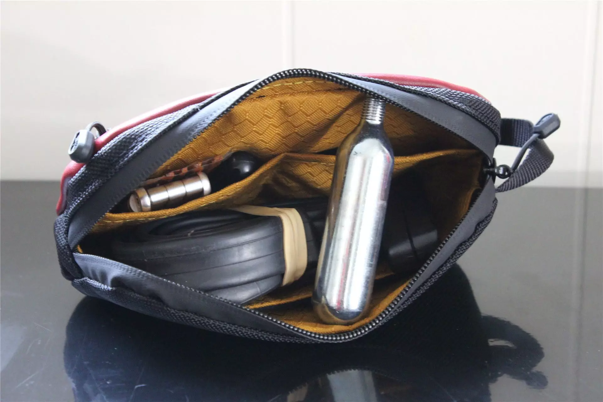 Sarung Alat Poket Jersi Waterfield dibuka dengan kartrij co2 untuk menunjukkan kandungannya dan bahagian dalam kantung