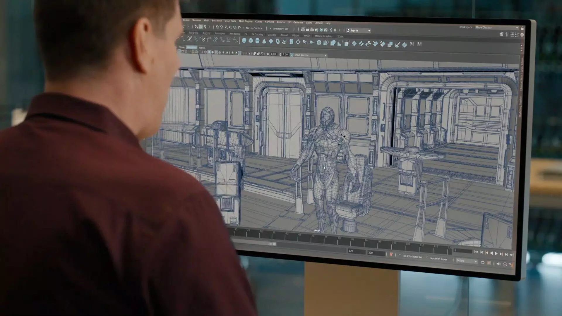 Omul se uită la monitor, un Mac bazat pe ARM, care rulează Maya.