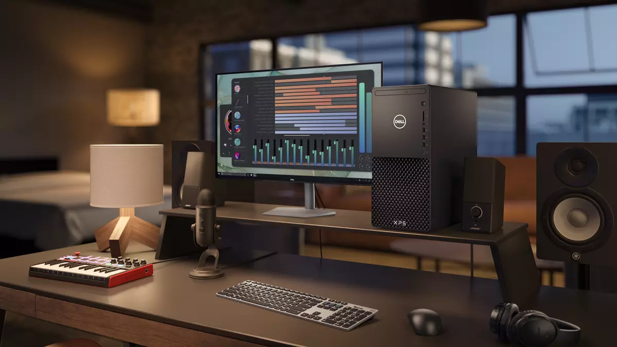 Det nye Dell XPS-skrivebordet på et skrivebord med trådløst tastatur og skjerm.