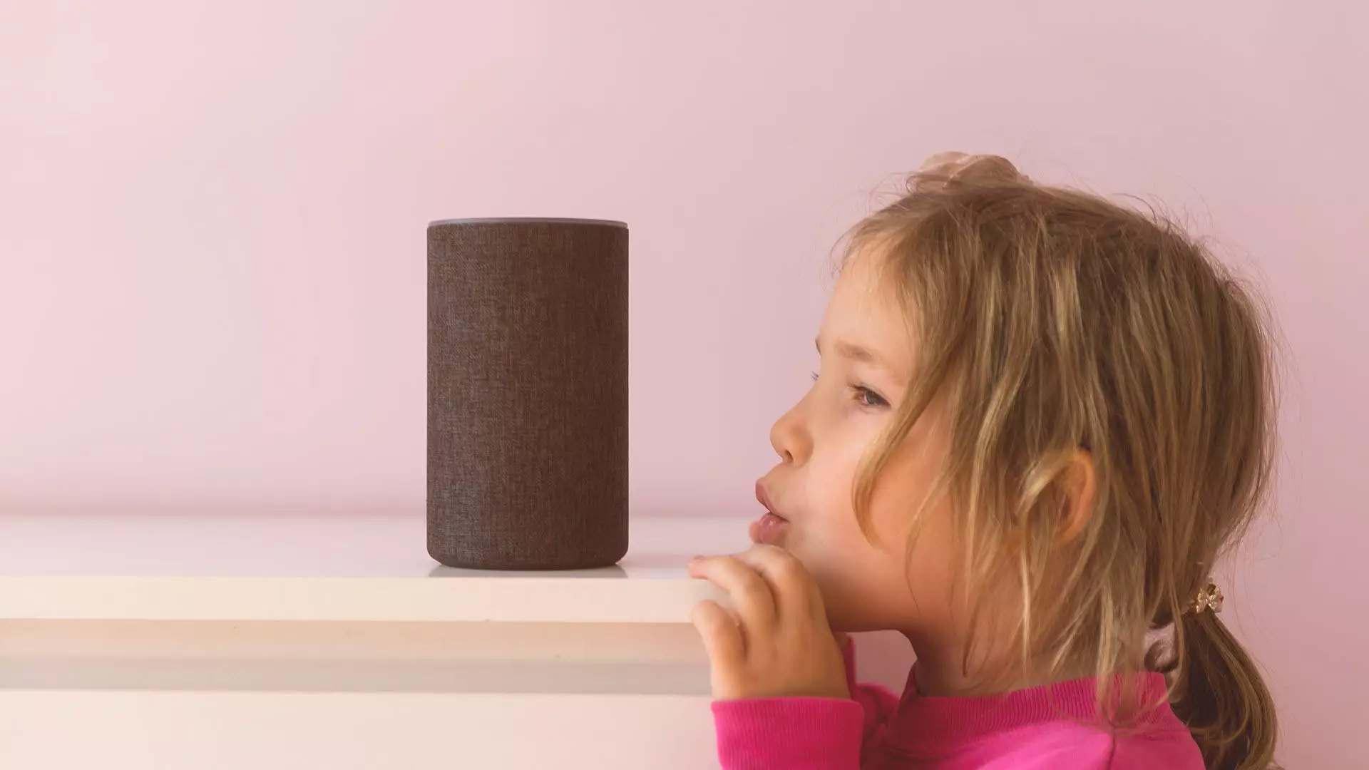 En liten jente snakker til et Amazon Echo