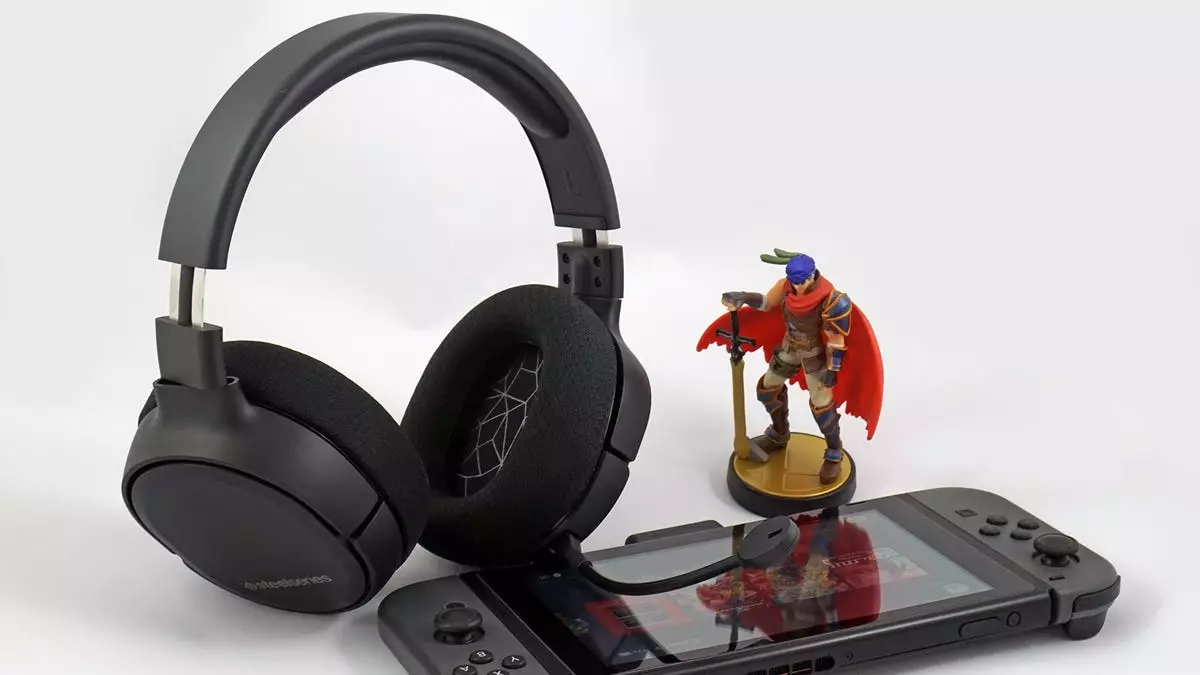 Els auriculars sense fil Arctis 1 asseguts al costat d'un Nintendo Switch.
