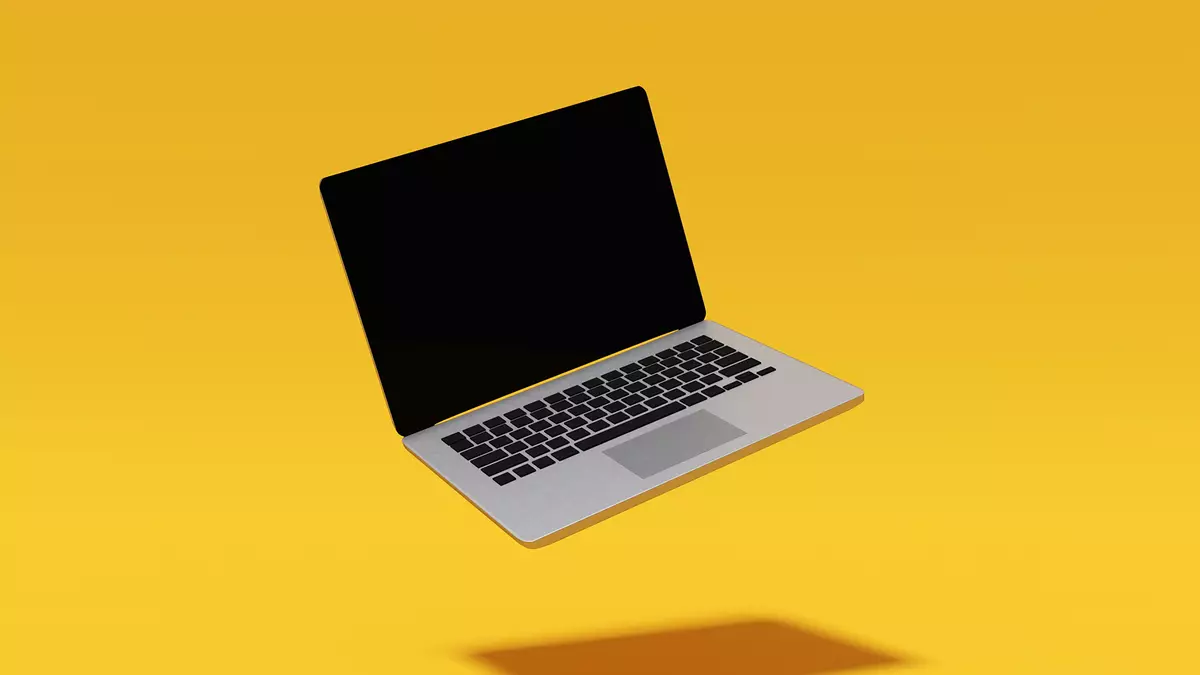 Laptop slim ngambang ing latar mburi kuning.